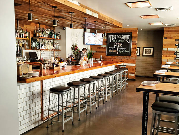 The bar area strikes that perfect balance between sophisticated and welcoming, where solo diners feel as comfortable as groups gathering for celebration.