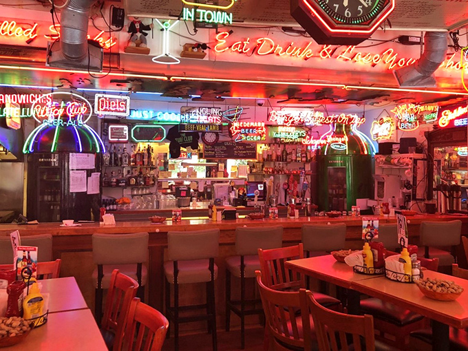 The bar area glows with decades of collected neon, creating an atmosphere that's equal parts nostalgic and energizing.