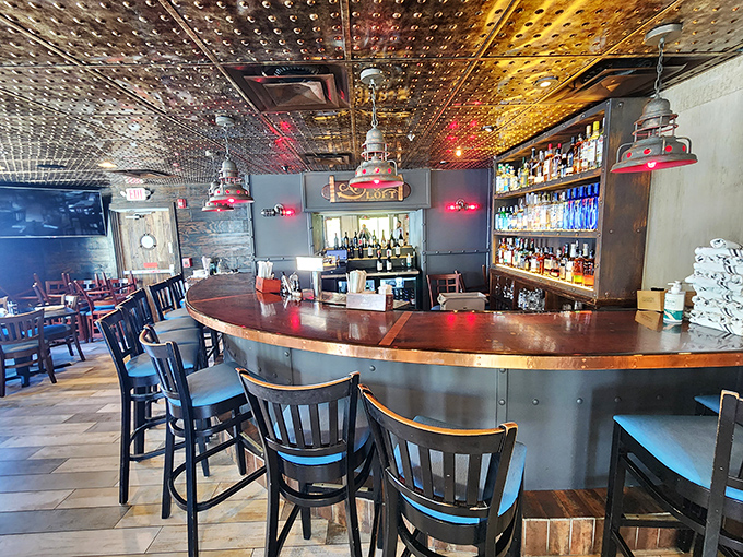 The copper-topped bar invites lingering conversations under a ceiling that gleams like the inside of a treasure chest.