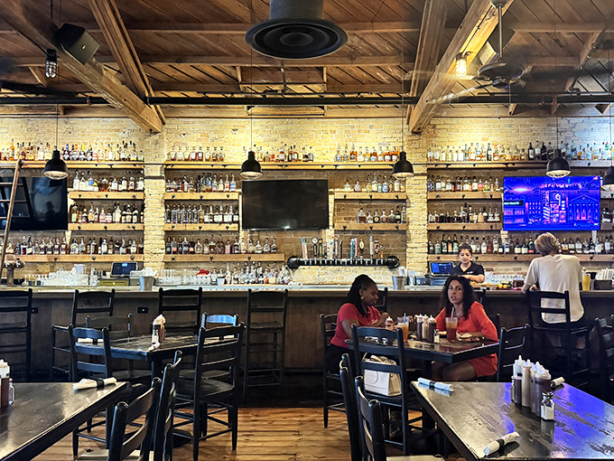 Where whiskey bottles stand at attention like soldiers guarding flavor, ready to be deployed for your sipping pleasure.