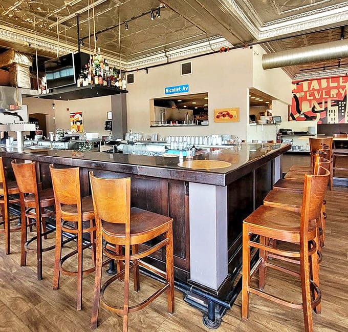 The bar area showcases an impressive selection of craft beverages, with game screens overhead ensuring you never miss a moment of digital action.