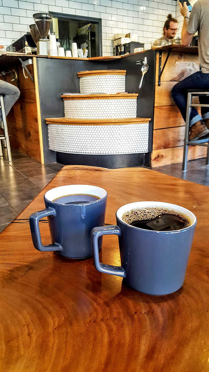Two mugs of black coffee on a wooden table &ndash; sometimes the simplest pleasures are the most profound.
