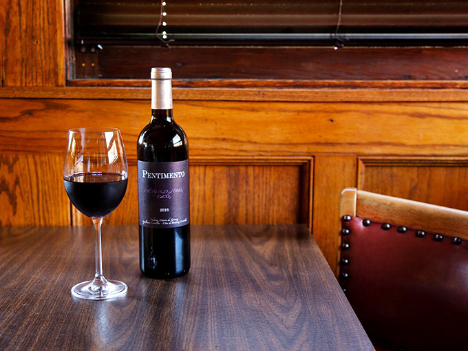 A thoughtfully selected wine bottle sits ready to complement your meal, because great food deserves equally great drinking companions at the table.
