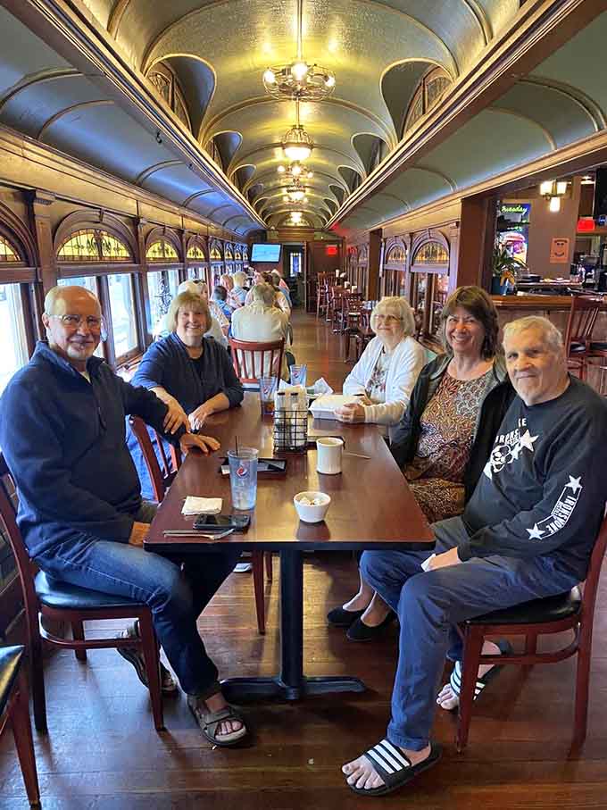Friends and family gather in the historic train car, where good food brings people together across generations.
