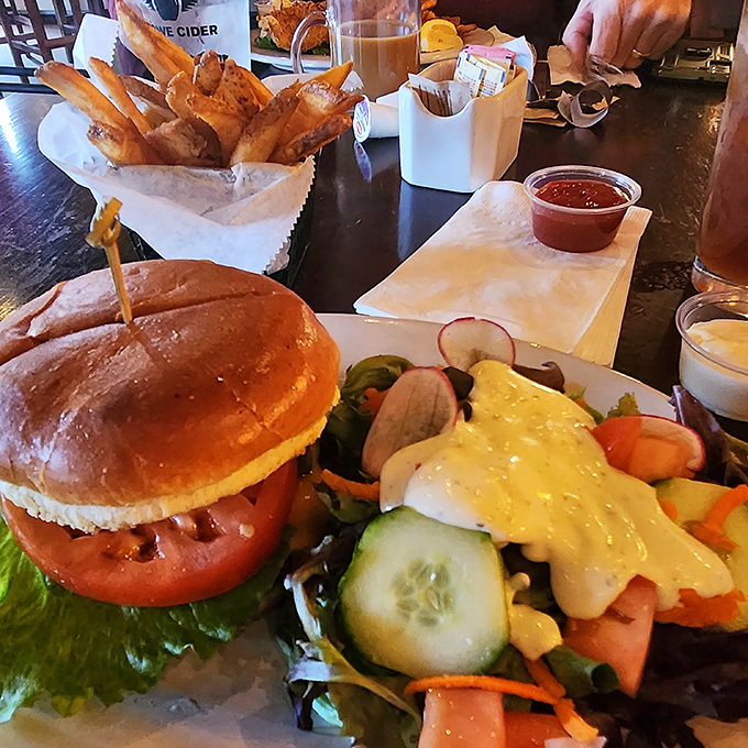 The perfect lunch trifecta: a juicy burger on a pillowy bun, garden-fresh salad, and golden fries that somehow manage to be both crispy and fluffy.