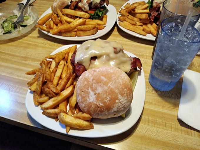 Open-faced perfection: melted cheese blankets a juicy burger patty, with fries standing at attention, ready for their supporting role.