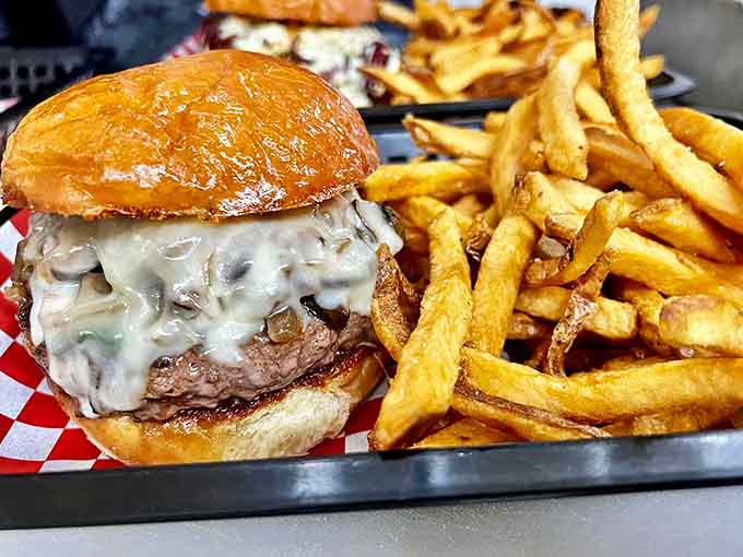 A burger and fries that belong in the comfort food hall of fame &ndash; notice how the cheese hugs the patty like it's never letting go.