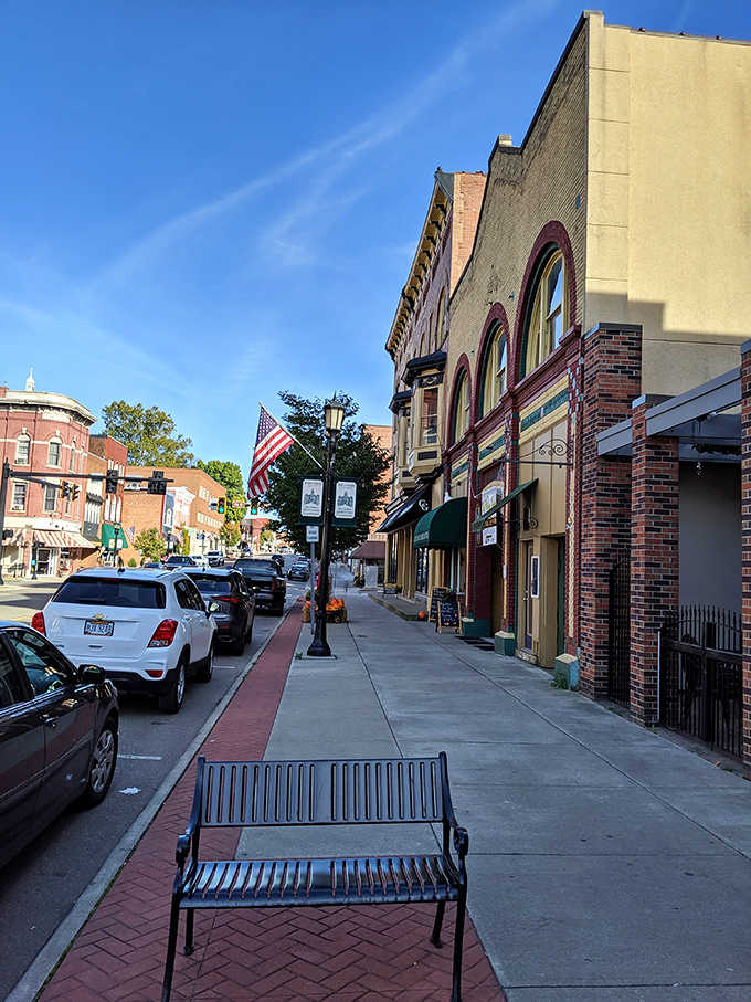 A thoughtfully placed bench invites passersby to pause and appreciate Cambridge's historic architecture and unhurried downtown atmosphere.