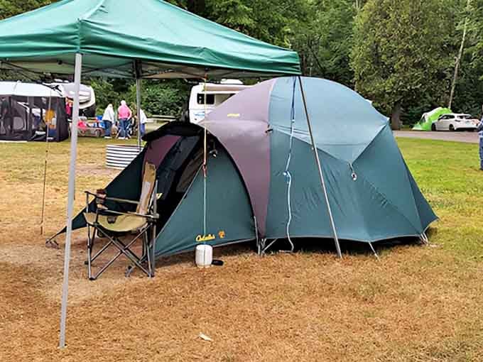 A cozy tent setup complete with canopy shows how campers create comfortable outdoor living rooms under Michigan's blue skies.