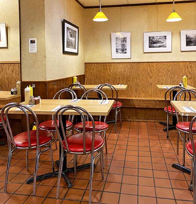 Every table tells a story, while yellow pendant lights cast a warm glow that makes everyone look like they're in a nostalgic film.
