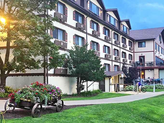 The resort's exterior at dusk glows with warmth that practically radiates welcome, like a hug you can see from the parking lot.