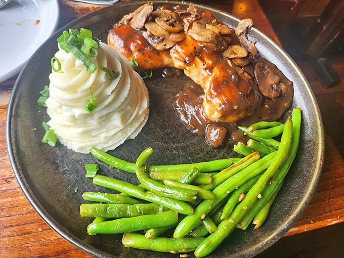 This chicken dish arrives with picture-perfect presentation – the meat glistening with sauce, alongside vibrant green beans and a cloud of whipped potatoes.