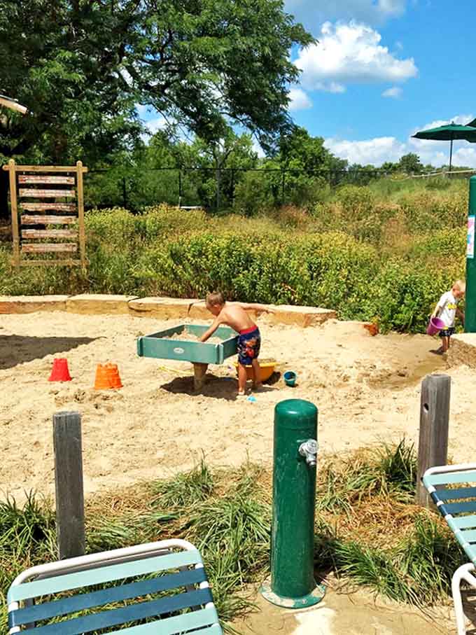 The sandbox area lets young architects create sandy masterpieces while parents enjoy the nearby shade and relative peace.