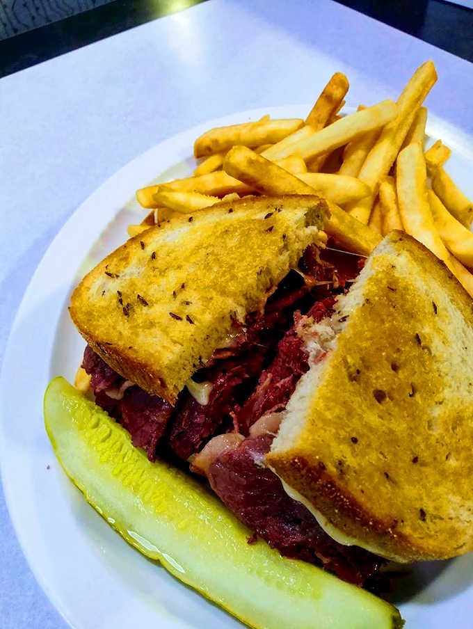 A monument to meat-stacking ambition, this rye-hugged beauty requires both hands, several napkins, and absolutely zero regrets.