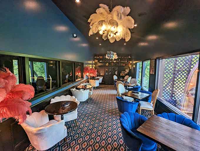 The lounge area with its bold blue seating and feathered chandeliers creates a space that's equal parts sophisticated and fun.