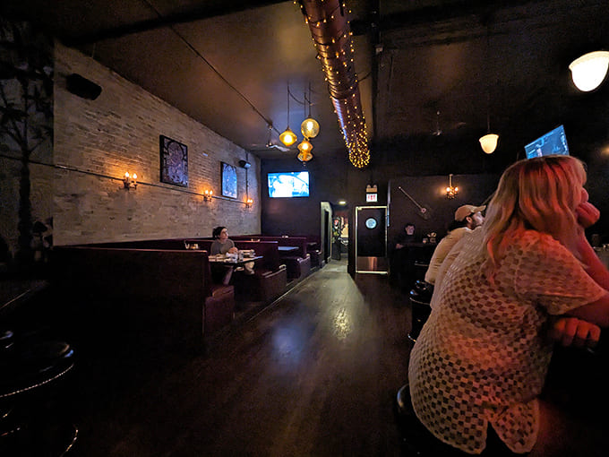 The dining area strikes that perfect balance between privacy and community &ndash; cozy booths invite conversation while ambient lighting sets the mood.