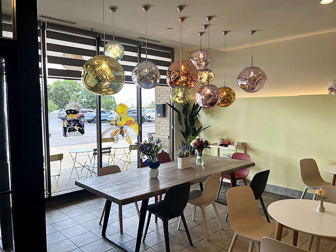 Bright, airy seating with fresh flowers because even donut shops can have standards and make you feel welcome at the same time.