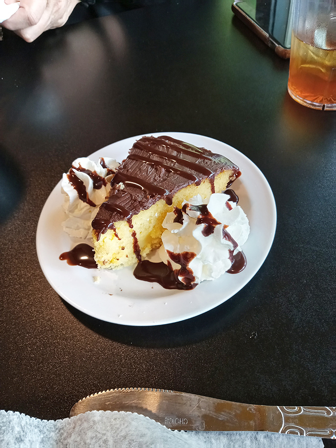 Boston cream pie with chocolate ganache and whipped cream &ndash; proof that happiness can indeed be served on a plate.