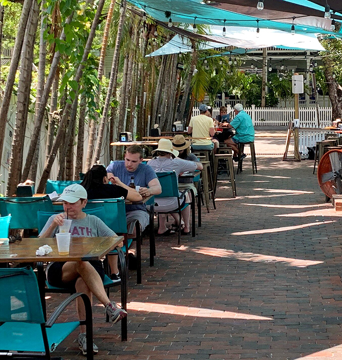 Diners: Happy food pilgrims enjoying their rewards under dappled sunlight, where strangers become friends over shared recommendations and food envy.