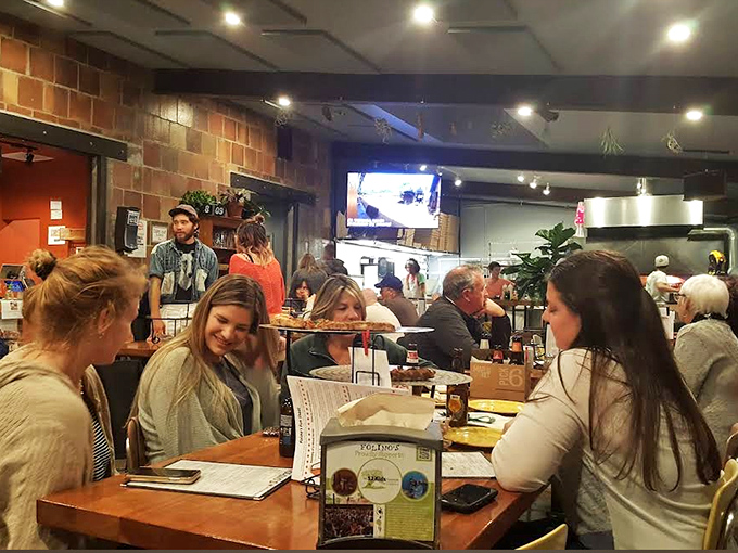 The dining room buzzes with the energy of happy eaters &ndash; a democratic space where everyone from college students to retirees unite over great pizza.