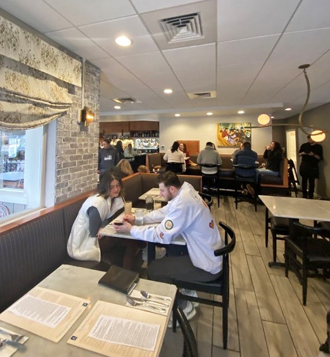 The dining room buzzes with happy conversation as patrons dive into plates of breakfast bliss in this welcoming space.