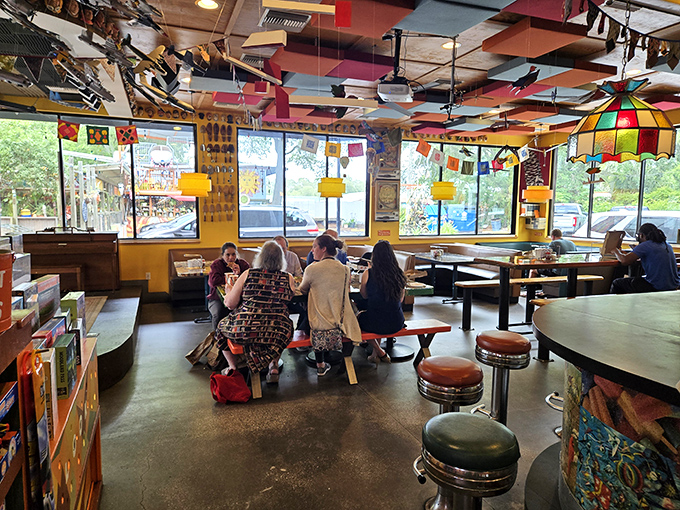 Mismatched furniture somehow creates perfect harmony in this dining space where every seat offers a different perspective on quirky perfection.
