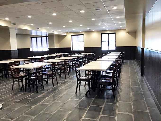 The dining area awaits the lunch rush, tables standing at attention like soldiers preparing for delicious duty.
