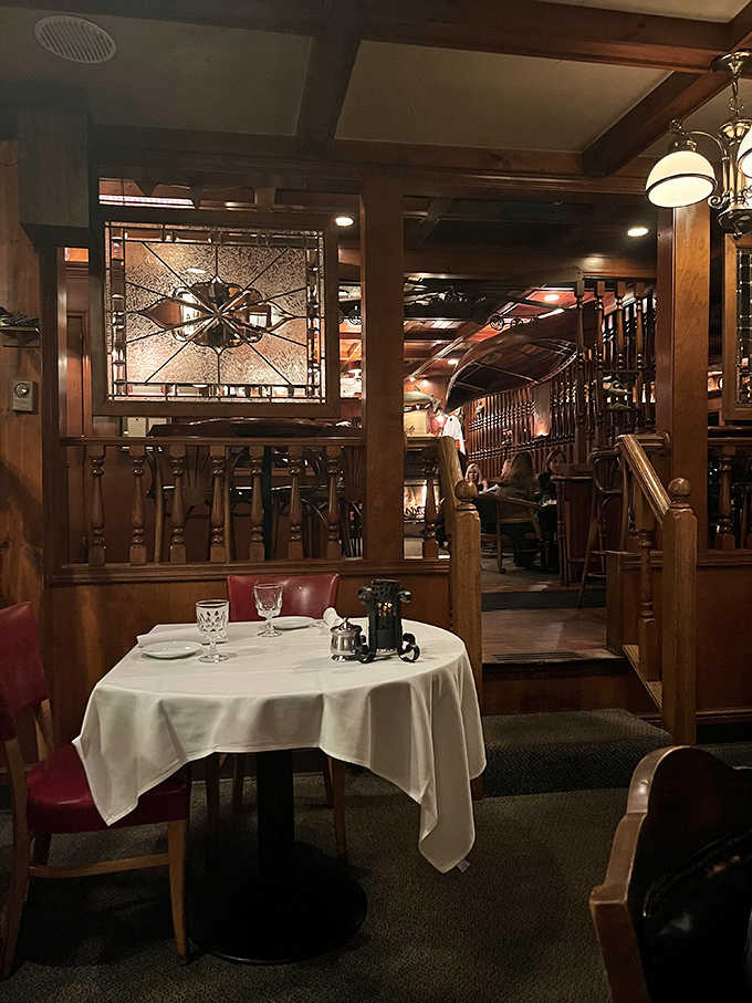 A table set for culinary memories, with stained glass accents casting warm light across white linens &ndash; the stage is set for an evening of exceptional dining.