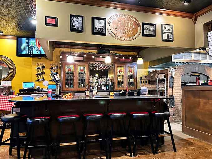 The bar at Dino's beckons with the promise of cold drinks and good times, the perfect complement to hot pizza and great company.