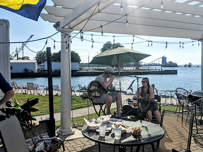 Diners soak up sunshine and live music under the pergola &ndash; the soundtrack of waves and acoustic guitar creating vacation vibes.