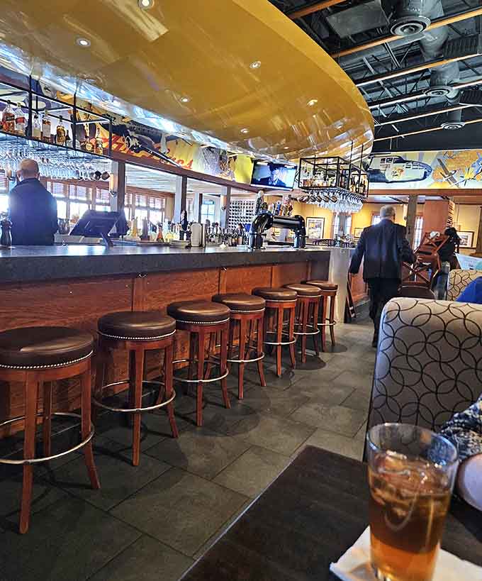The bar area beckons with its impressive selection of bottles and that overhead glass rack that screams sophisticated without being stuffy.