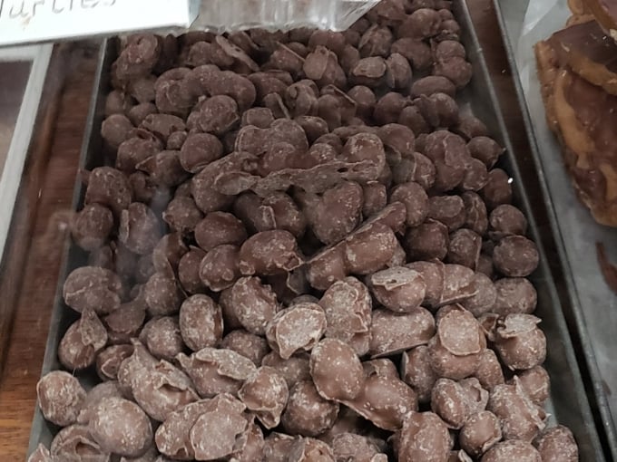 These chocolate-covered peanuts wear their cocoa coats with pride, ready to deliver that perfect crunch-to-chocolate ratio.