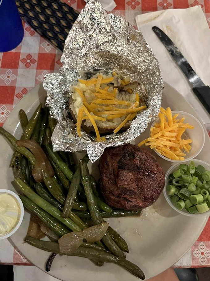 A perfectly cooked steak beside a baked potato that's practically begging for that fork &ndash; simple perfection that needs no fancy frills.