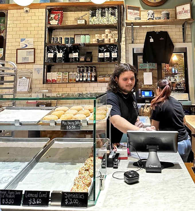 Behind that counter, staff members orchestrate donut distribution with the efficiency of people who understand the urgency of sugar cravings.