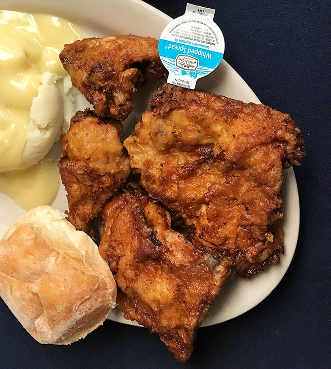 The image appears to show some kind of food item, possibly fried chicken, though the purple filter makes it difficult to identify clearly.