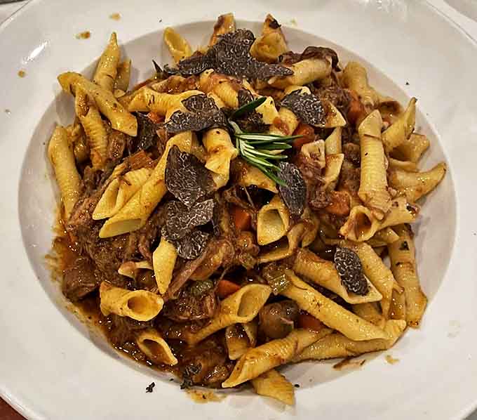Rich meat ragu clinging to perfectly cooked pasta with a generous shaving of truffle, because sometimes more is more.