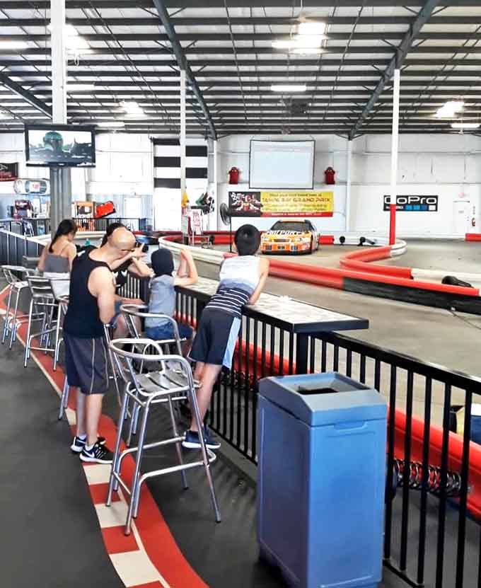 Spectators line the rails, offering unsolicited advice and occasionally wincing when racers take corners with more optimism than skill.