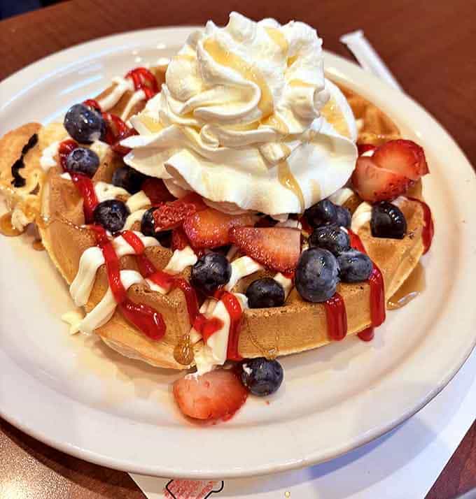 Belgian waffle loaded with fresh berries and whipped cream, because sometimes breakfast should double as dessert without any apologies needed.