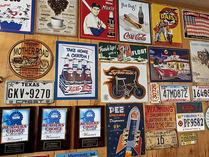 A gallery of Americana covers every inch of wall space &ndash; vintage signs, license plates, and memorabilia creating a museum of nostalgia.