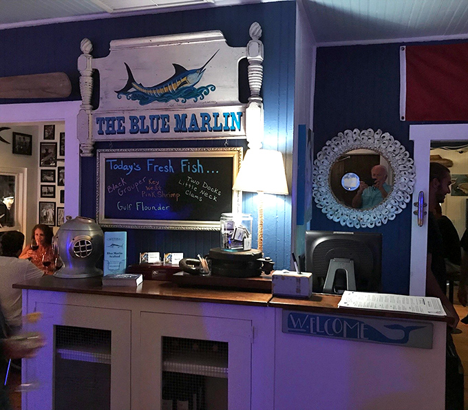 The welcome desk announces today's fresh catch on a chalkboard—what was swimming this morning could be your dinner tonight.