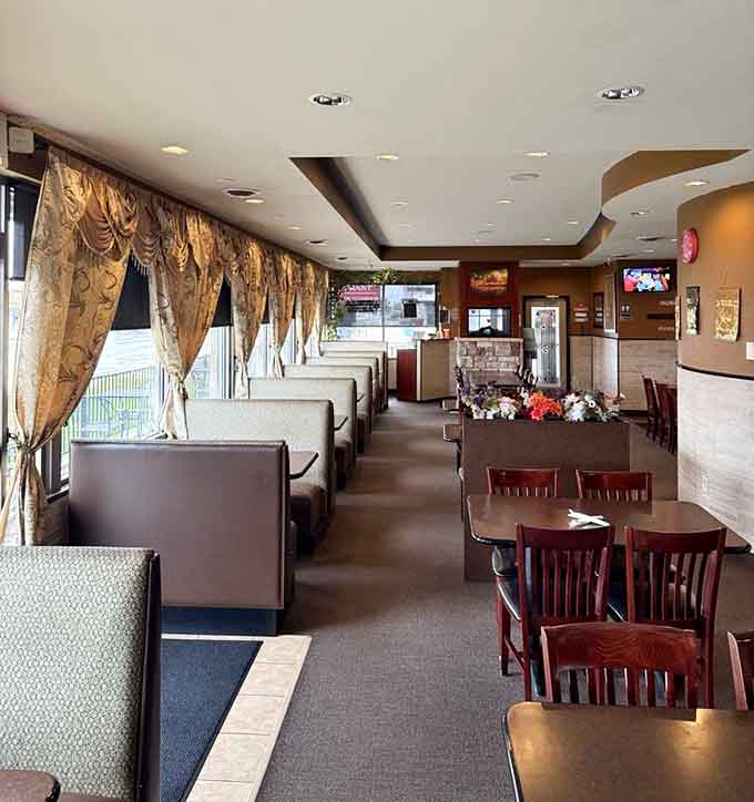 The spacious dining area features comfortable booths and tables where families, couples, and friends gather to share incredible meals and create lasting memories.