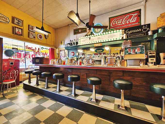 The vintage soda fountain counter gleams with chrome and possibility, inviting you to pull up a stool and stay awhile.