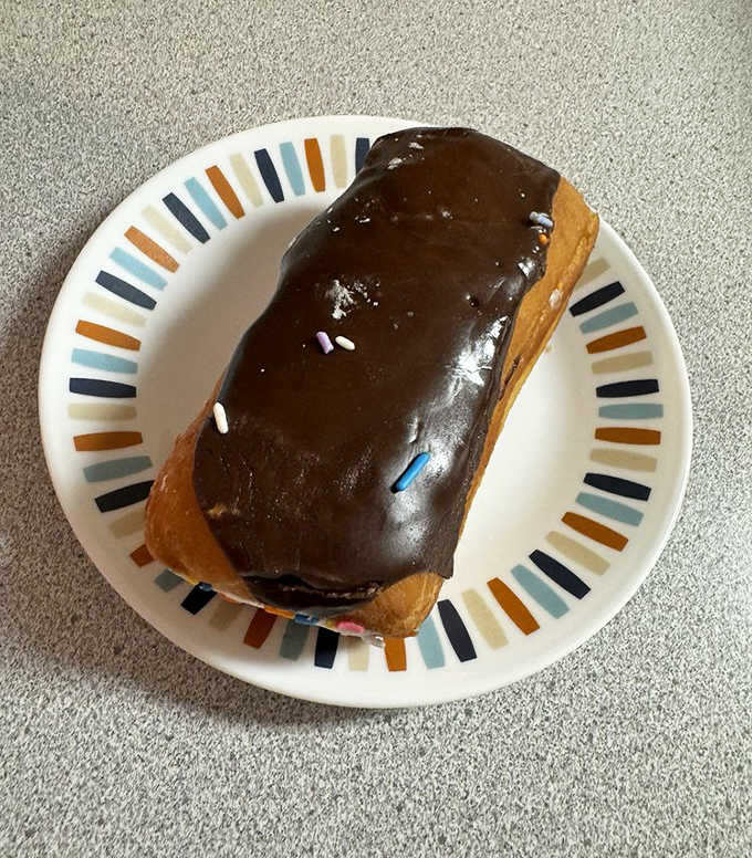 This chocolate-topped long john isn't just a donut &ndash; it's a commitment to happiness that stretches as far as its delicious form.