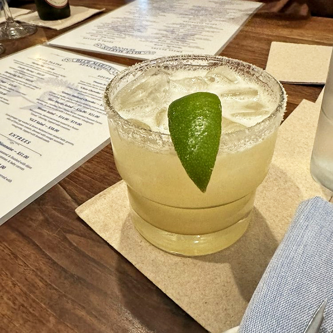 The house margarita arrives with a salted rim and lime wedge &ndash; simple, classic perfection that complements rather than competes with seafood.