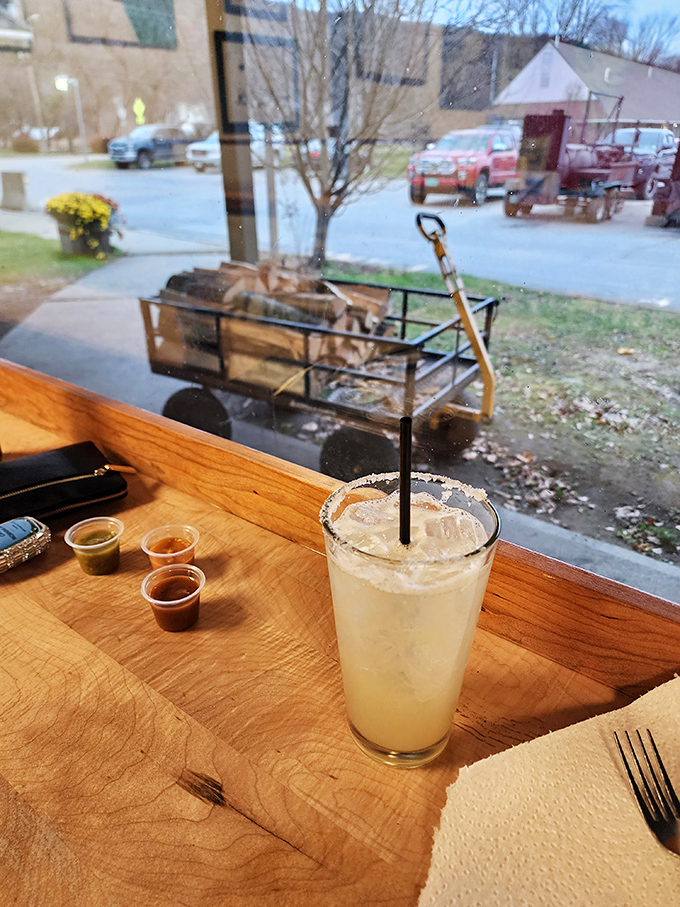 A frosty margarita with salt-rimmed precision sits by the window, ready to complement smoky flavors with its bright, citrusy punch.