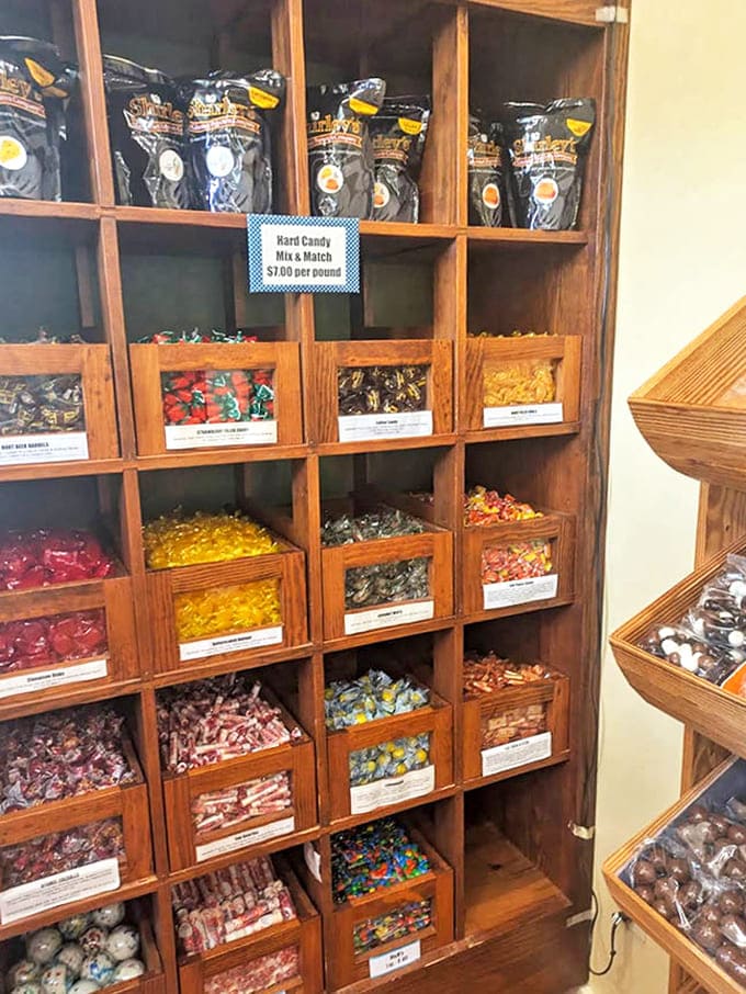 Old-fashioned wooden compartments house a rainbow of hard candies and treats, a nostalgic nod to simpler times when candy was special.