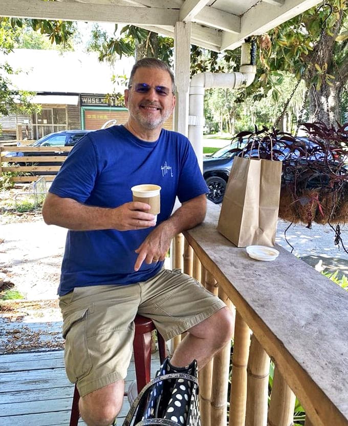 A moment of pure contentment captured&mdash;coffee in hand, sunshine filtering through oak trees, and not a care in the world.