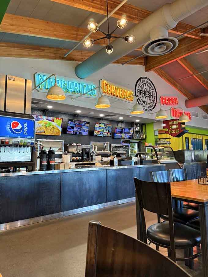 The ordering counter with colorful neon signs and menu boards makes choosing your meal an exciting visual experience.