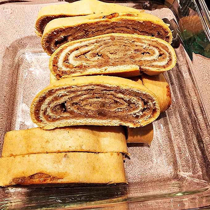 Cross-sections of nut rolls reveal their hypnotic spirals, each layer telling the story of dough rolled thin and filling spread with expert precision.
