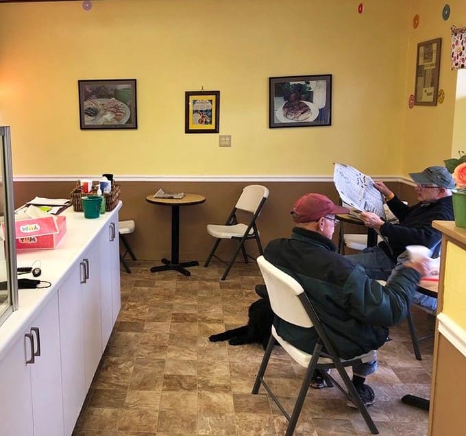 Local customers settling in with their morning donuts, living their best life one bite at a time in this cozy corner spot.